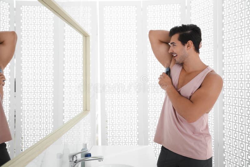 Handsome Young Man Deodorant in Bathroom Stock Photo - Image of beauty ...