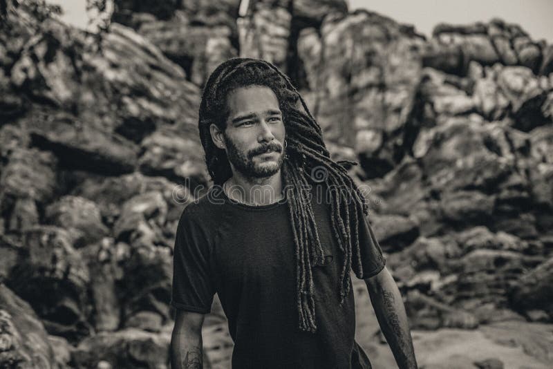 Handsome Young Man with Dreadlocks Outdoors. Male Model at the Rocks ...