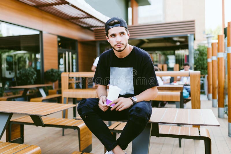 Handsome Young Man Drinking Refreshment at Outdoor Bar. Stock Photo ...