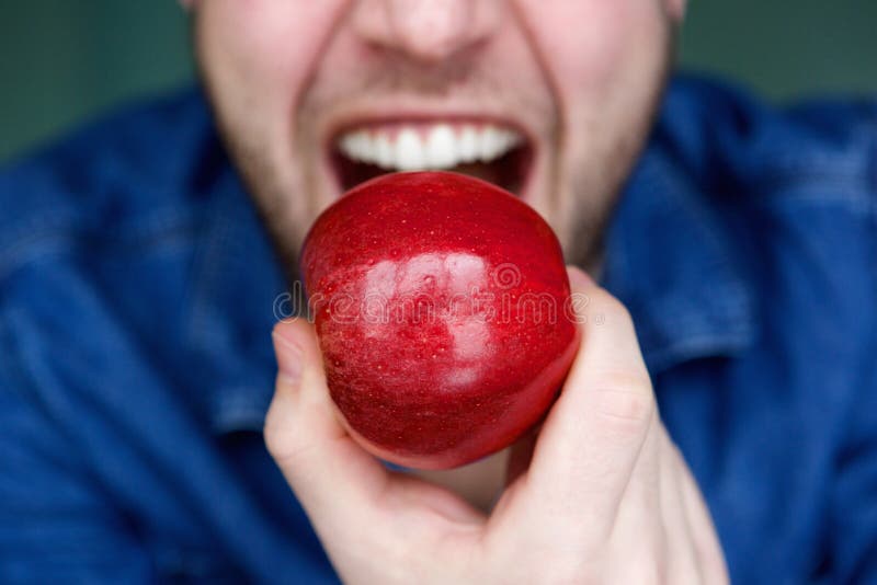 Handsome Young Man Eating Red Apple Stock Photo - Image of lunch, diet ...