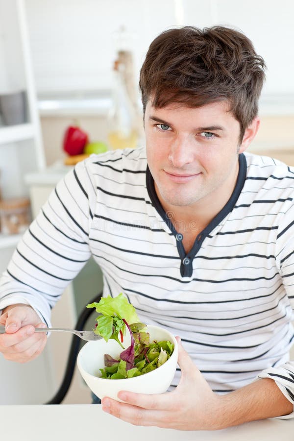Handsome Young Man Eating a Salad in the Kitchen Stock Image - Image of ...
