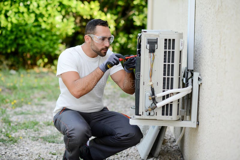 Handsome Young Man Electrician Installing Air Conditioning in a Client ...
