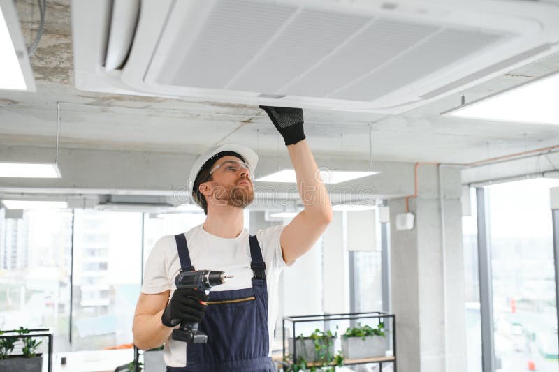 Handsome Young Man Electrician Installing Air Conditioning. Stock Photo ...