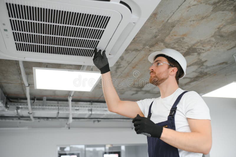 Handsome Young Man Electrician Installing Air Conditioning. Stock Photo ...