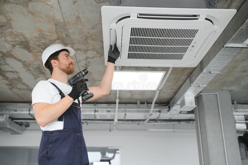 Handsome Young Man Electrician Installing Air Conditioning. Stock Photo ...