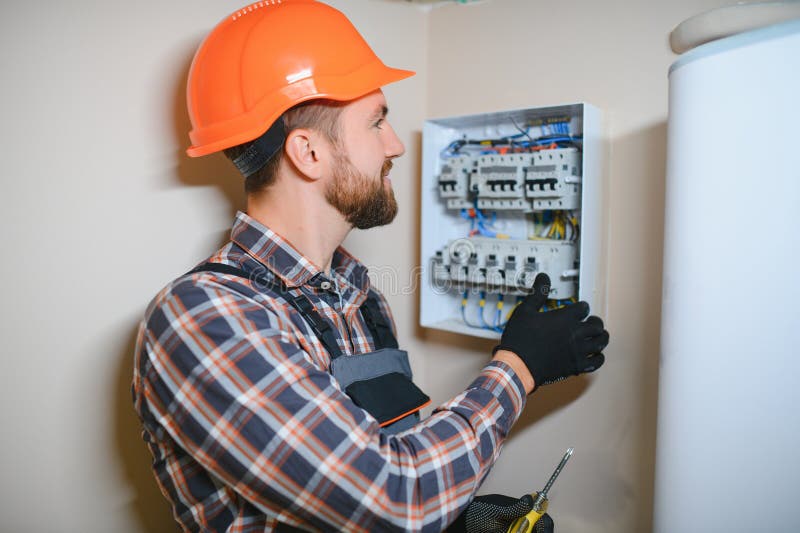 Handsome Young Man Electrician Working on Switchboard of House Building ...