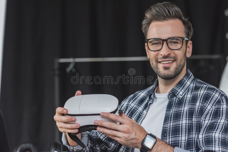 Handsome Young Man in Eyeglasses Holding Virtual Reality Headset and ...