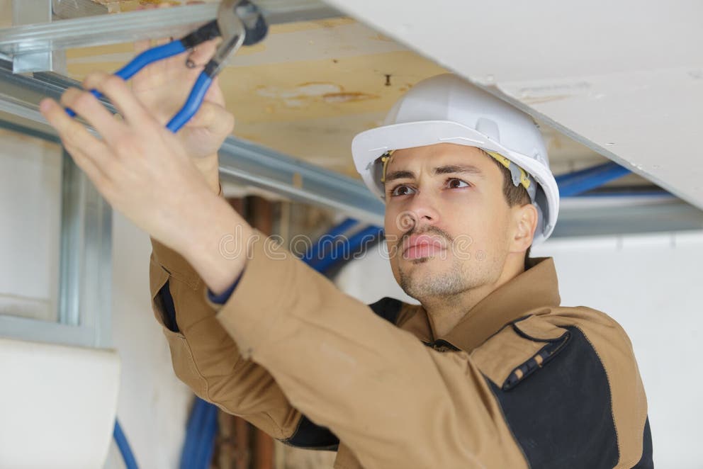 Handsome Young Man Fixing Ceiling Panel with Pliers Stock Image - Image ...