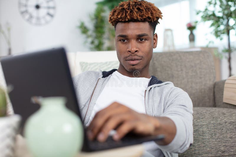 Handsome Young Man on Floor at Home Browsing Internet Stock Image ...