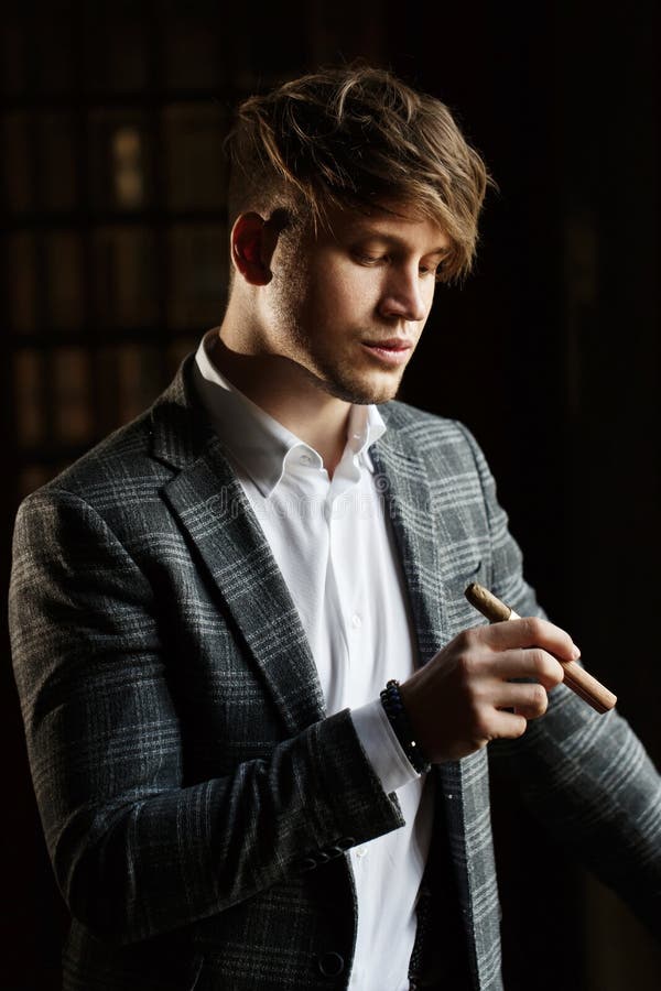 Handsome Young Man in Grey Suit Stands with a Cigar Stock Image - Image ...
