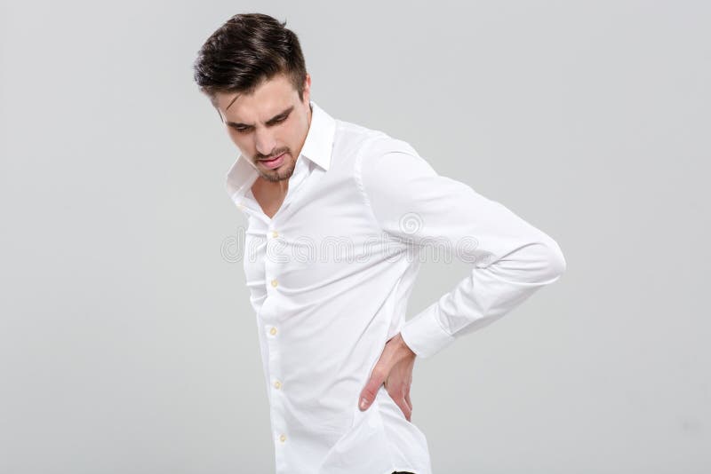 Handsome Young Man Has a Backache Stock Photo - Image of upset, studio ...