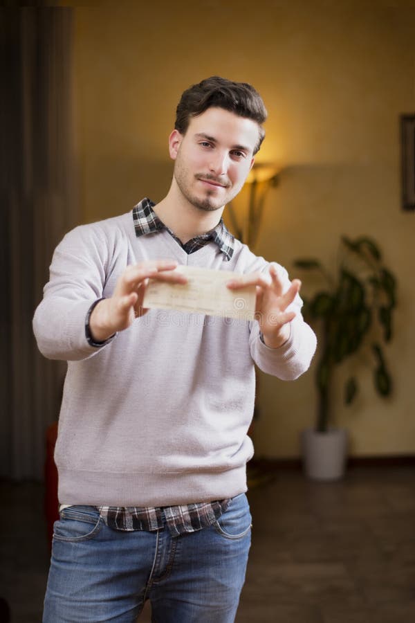 Smiling Young Man with Check in His Hands Stock Photo - Image of smile ...