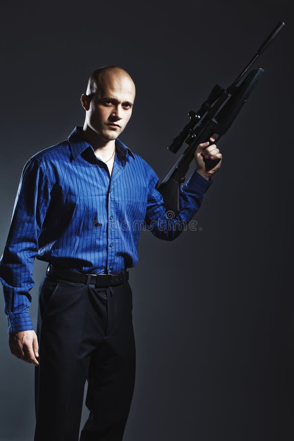 Handsome Young Man Holding a Gun. Stock Photo - Image of expression ...