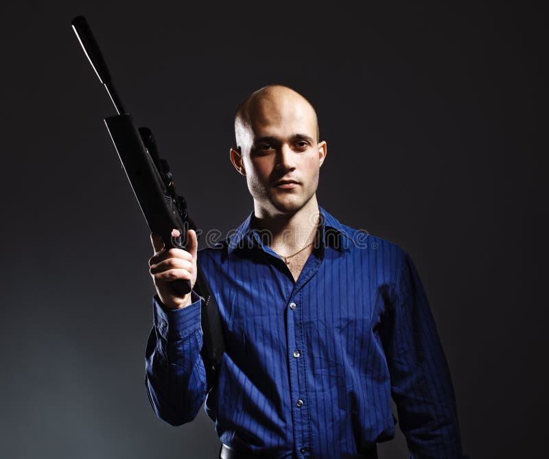 Handsome Young Man Holding a Gun. Stock Photo - Image of basher, beauty ...