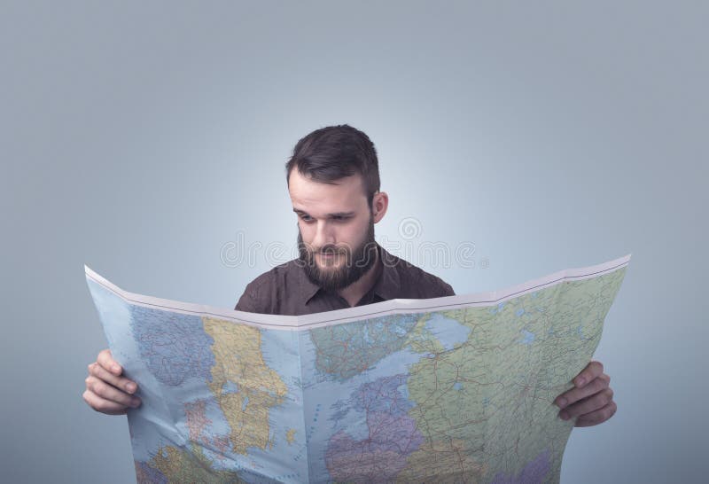 Young man holding map stock image. Image of destination - 102128047