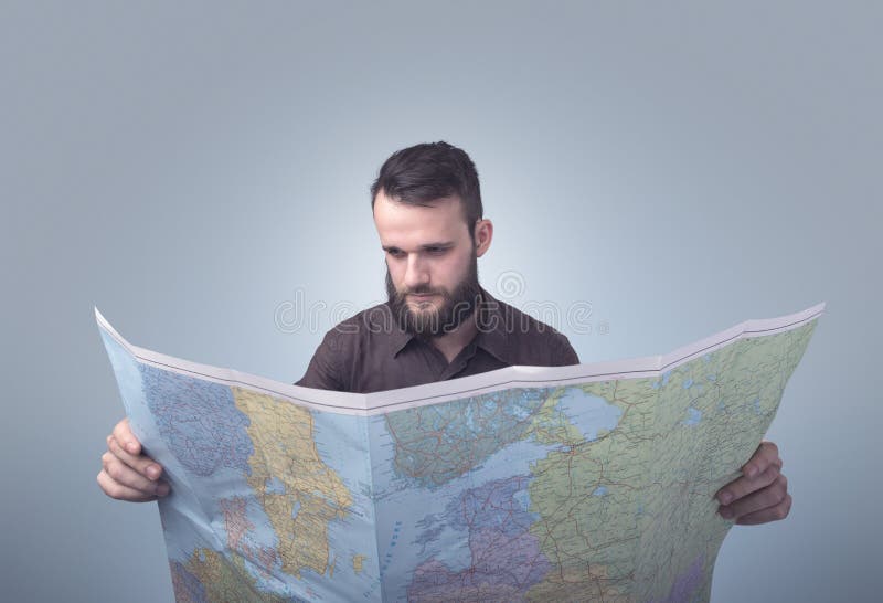 Young man holding map stock photo. Image of person, city - 103936510