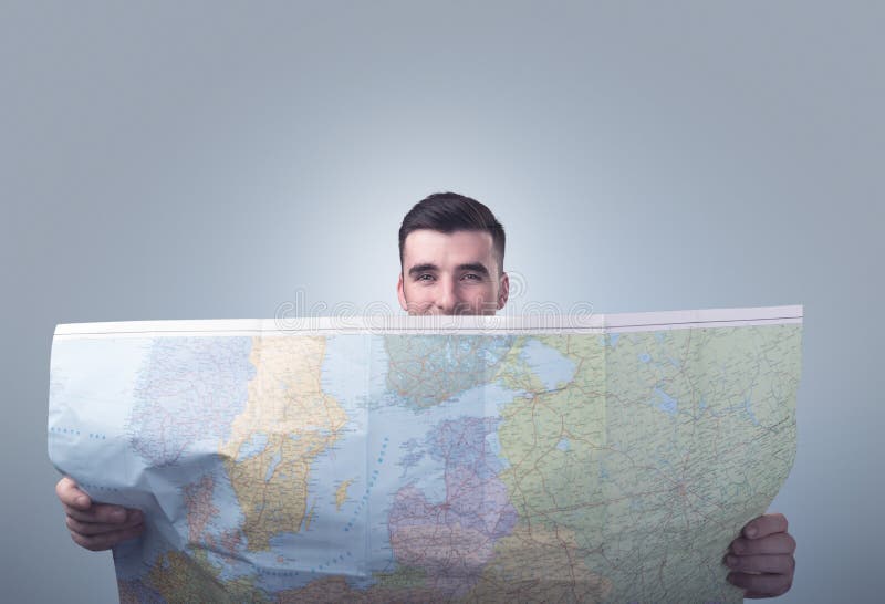 Young man holding map stock photo. Image of adult, lifestyle - 104942582