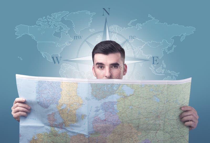 Young man holding map stock photo. Image of background - 115234128