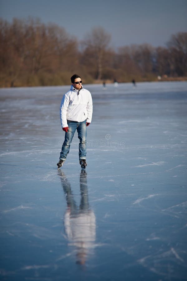Handsome Young Man Ice Skating Outdoors on a Pond Stock Image - Image ...