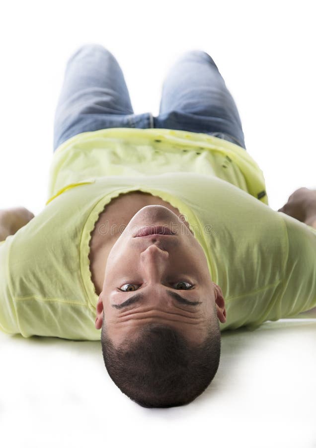 Handsome Young Man Laying on the Floor, Belly Up Stock Photo - Image of ...