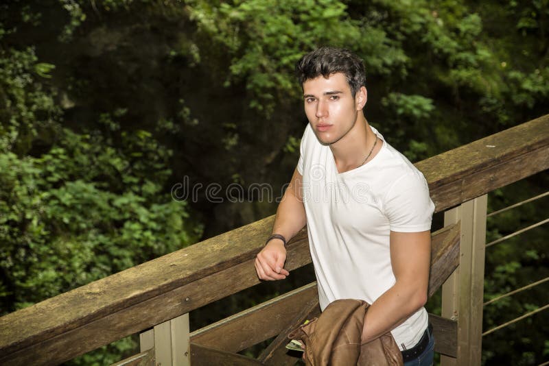 Handsome Young Man Leaning Against Pathway Rail Stock Image - Image of ...