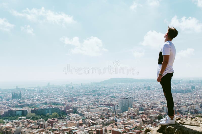 Handsome Young Man Looking at the Views Form the Top of a Mountain ...