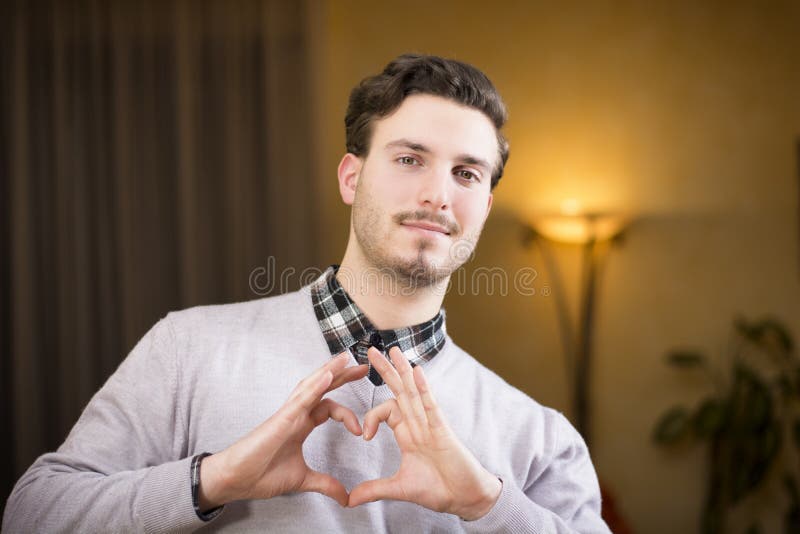 Handsome Young Man Making Heart Sign with Hands Stock Photo - Image of ...