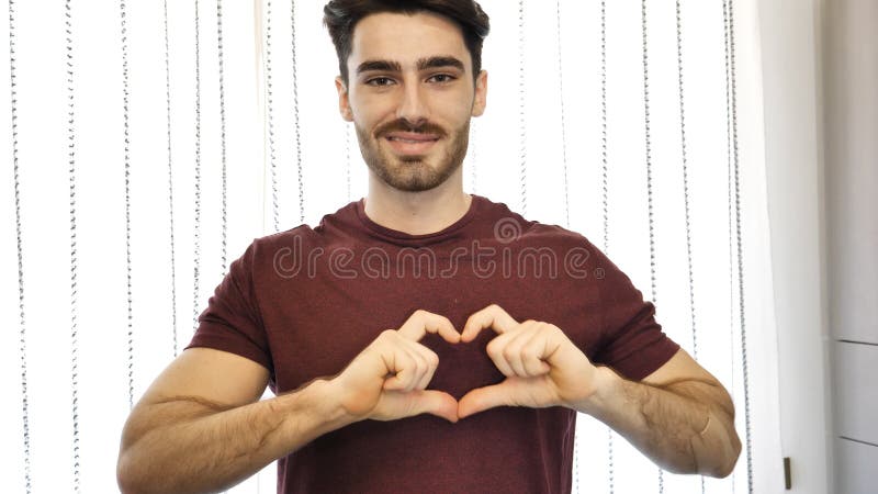 Handsome Young Man Making Heart Sign with Hands Stock Photo - Image of ...