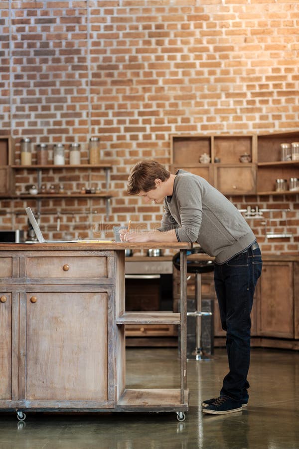 Handsome Young Man Making Notes on Kitchen Counter Stock Image - Image ...