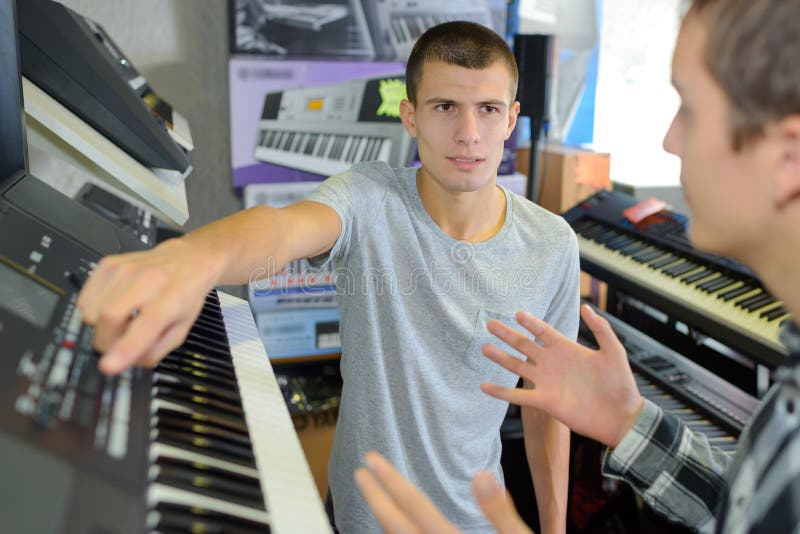 Handsome Young Man in Music Store Stock Photo - Image of instrument ...