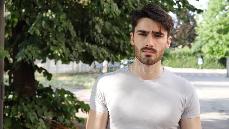 Handsome young man outdoor stock photo. Image of beard - 99527636