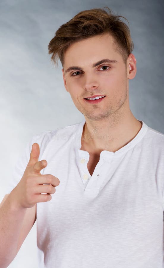 Handsome Young Man Pointing Towards Camera. Stock Image - Image of ...