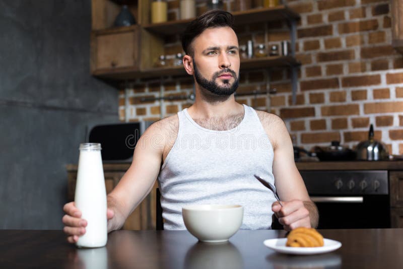 Handsome Young Man Pouring Milk from Bottle Stock Image - Image of pour ...