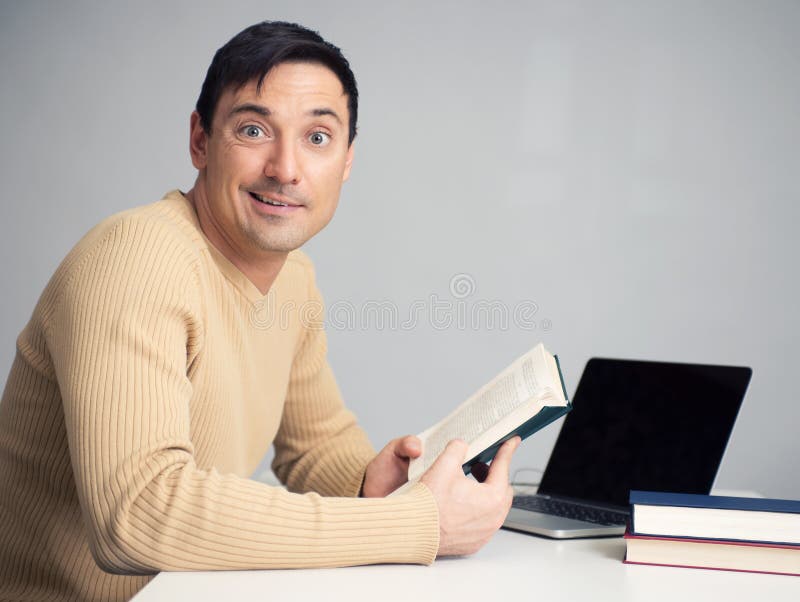 Handsome Young Man Reading a Book Stock Photo - Image of studio ...