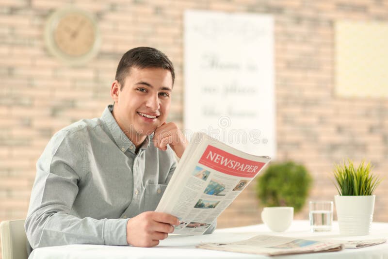 Handsome Young Man Reading Newspaper in Cafe Stock Image - Image of ...