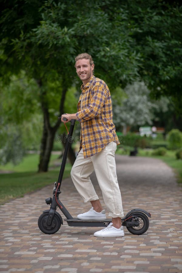 Handsome Young Man Riding a Scooter and Smiling Stock Image - Image of ...