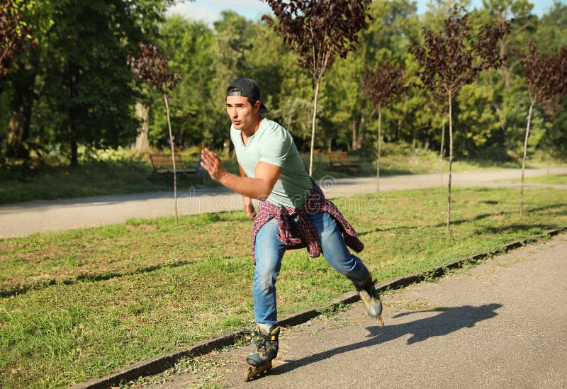 Handsome Young Man Roller Skating Stock Photo - Image of adult ...