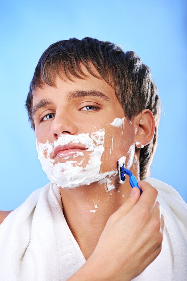 Handsome young man shaving stock image. Image of portrait - 13173773