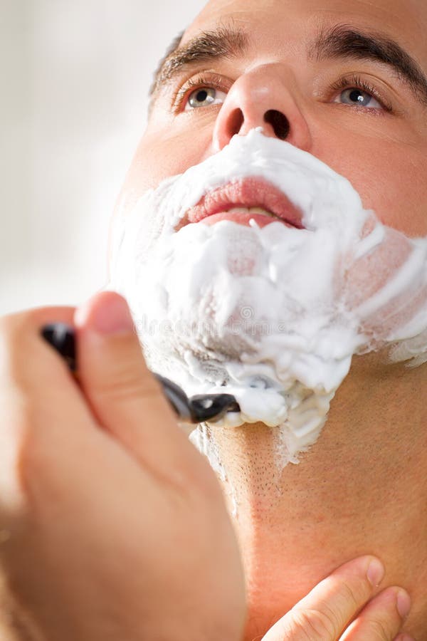 Handsome Young Man is Shaving His Face Stock Photo - Image of face ...