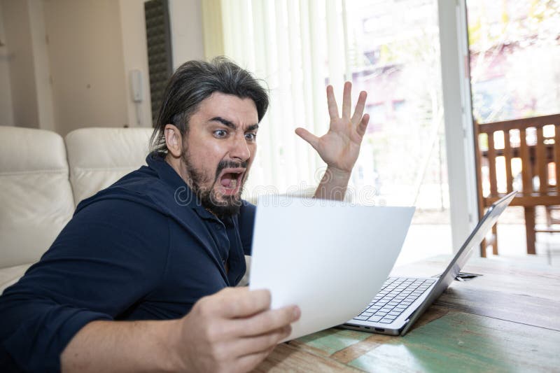 Handsome Young Man Shocked Over High Bill in Office Stock Image - Image ...