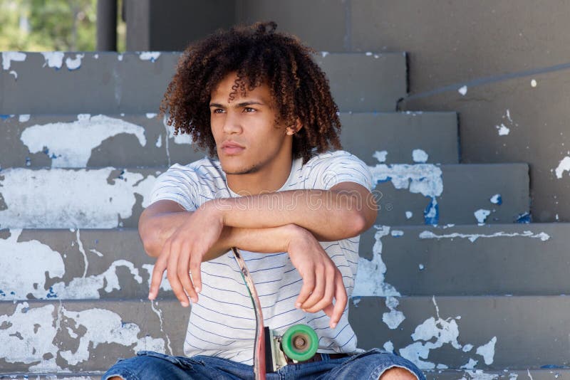 Handsome Young Man Smiling with Arms Crossed Against Gray Wall Stock ...