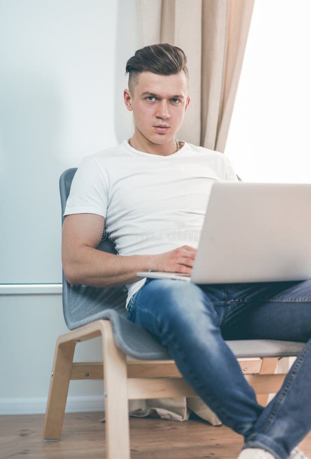 Handsome Young Man Sitting and Working on Laptop Computer Stock Image ...