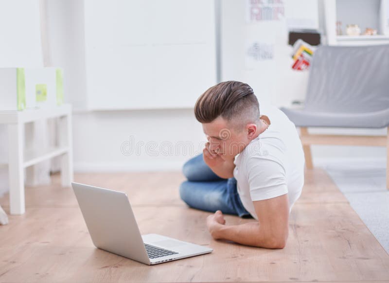 Handsome Young Man Sitting and Working on Laptop Computer Stock Photo ...