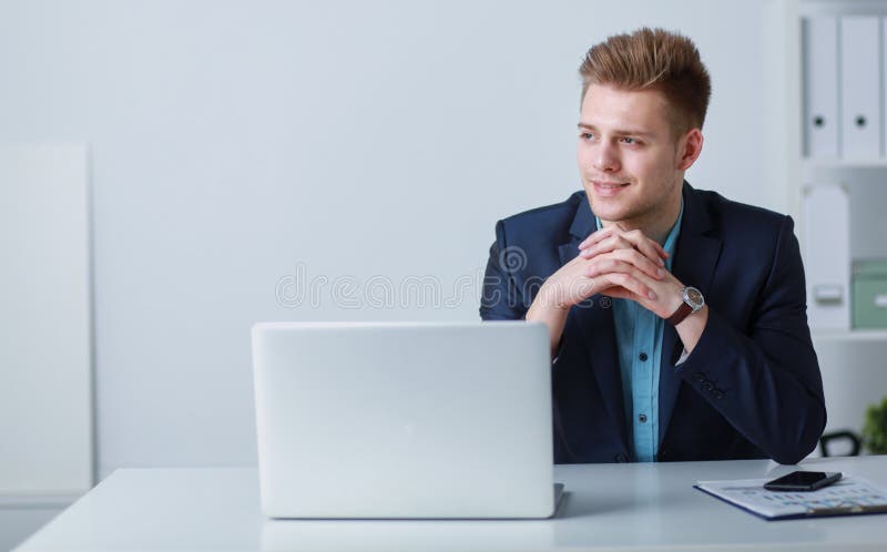 Handsome Young Man Sitting and Working on Laptop Computer Stock Photo ...
