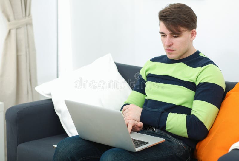 Handsome Young Man Sitting and Working on Laptop Computer Stock Image ...