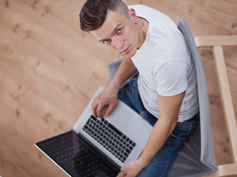Handsome Young Man Sitting and Working on Laptop Computer Stock Photo ...