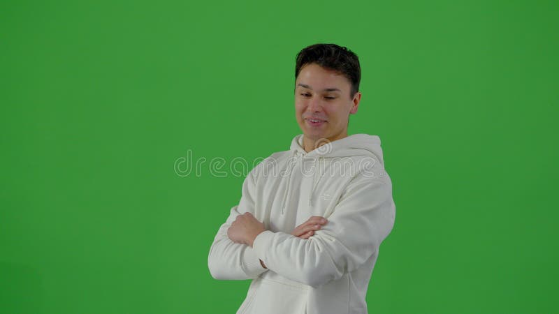 Handsome Young Man Smiles at the Camera in a Green Screen Studio Stock ...