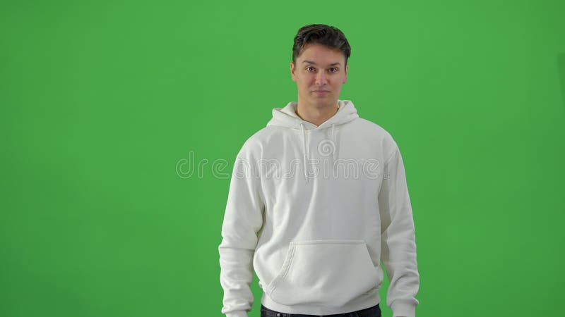 Handsome Young Man Smiles at the Camera in a Green Screen Studio Stock ...