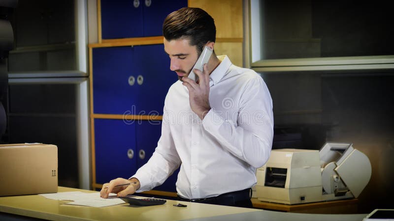Man Looking at Documents at Office Counter Stock Photo - Image of ...