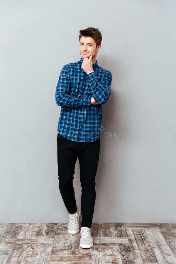 Handsome Young Man Standing Over Grey Wall and Posing Stock Photo ...
